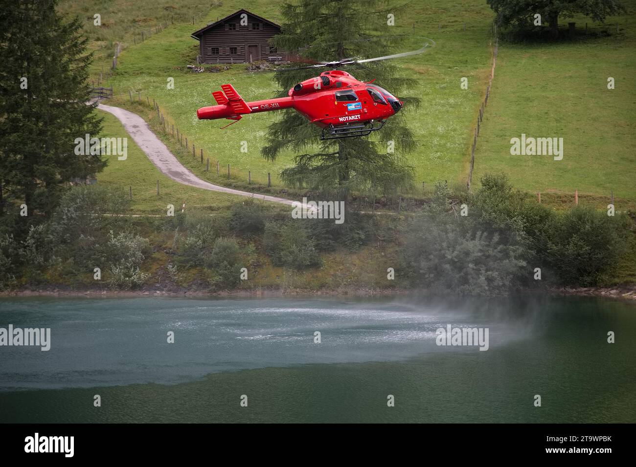 helicopter landing by a lake in austria Stock Photo - Alamy
