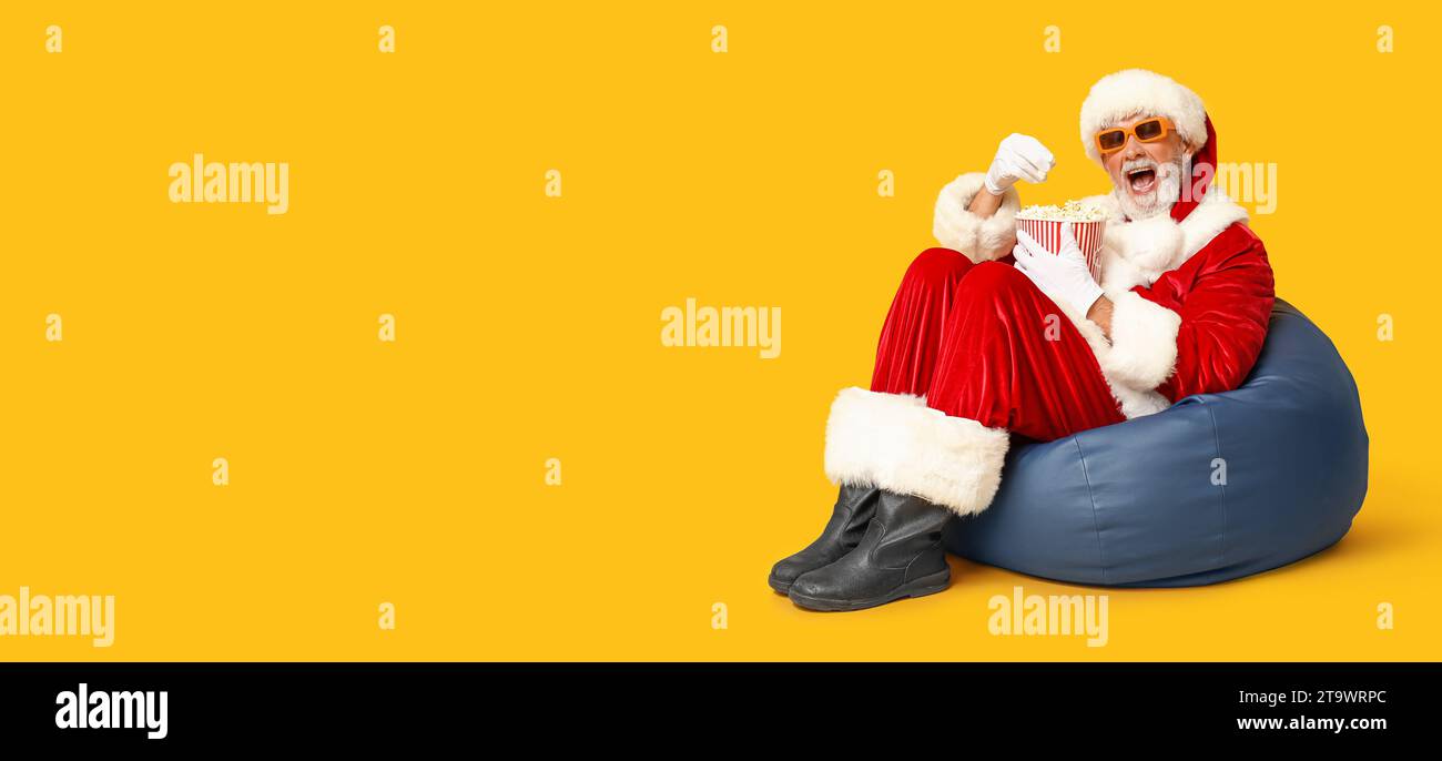 Santa Claus eating popcorn and watching Christmas movie against yellow ...