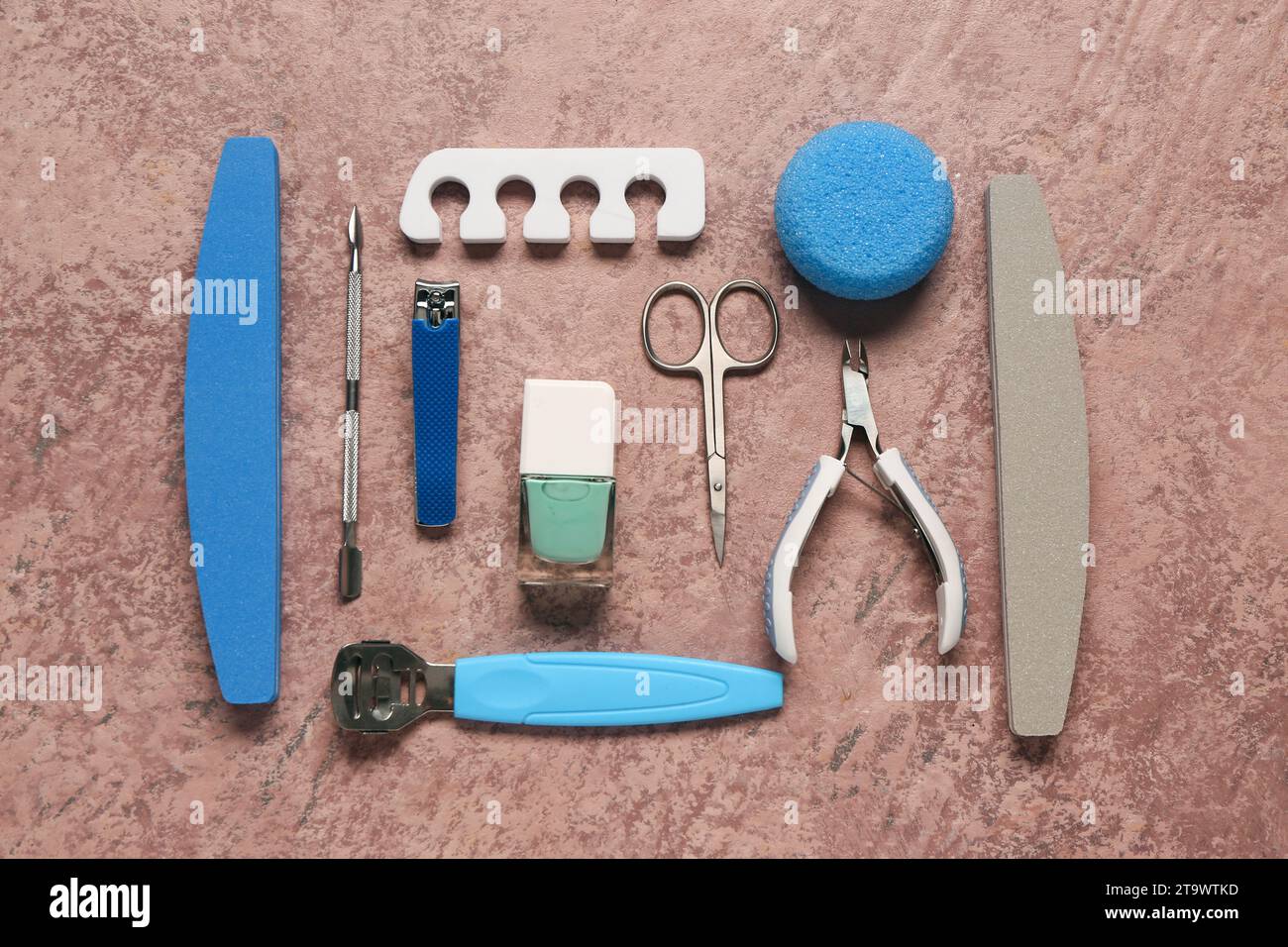 Set of professional tools for pedicure with nail polishes on grunge ...