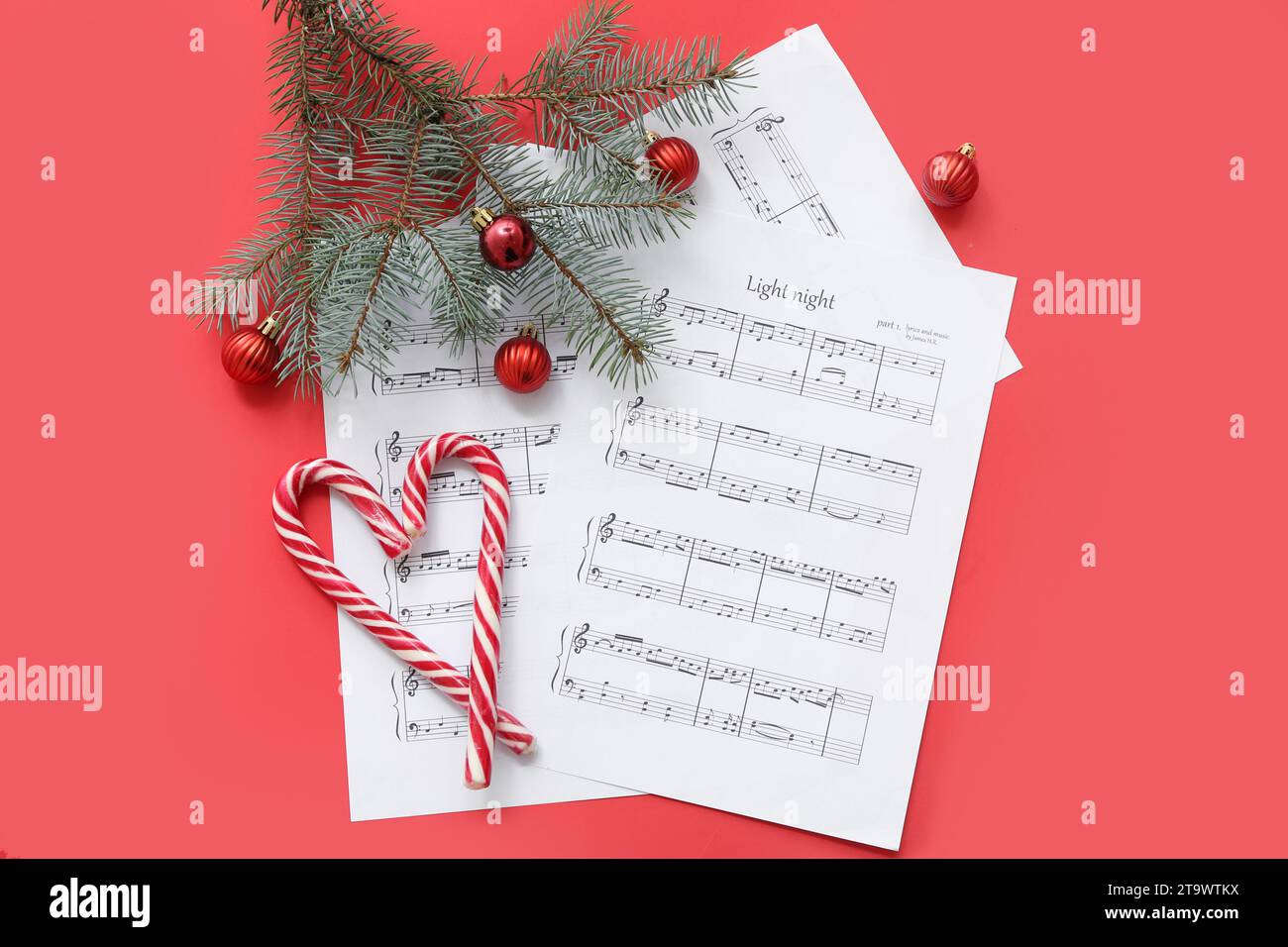 Music note sheets with Christmas decor on red background Stock Photo ...