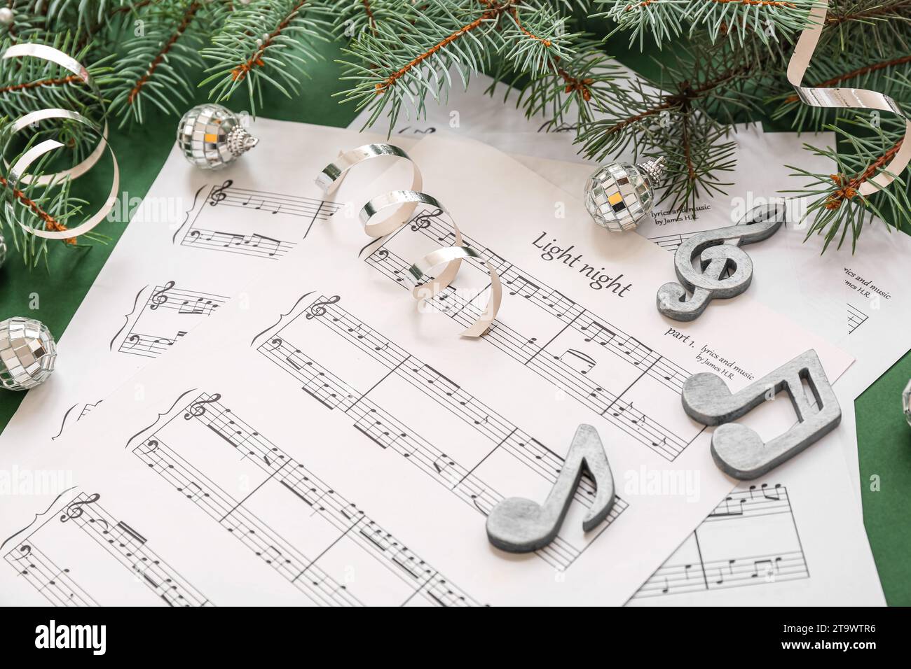 Music note sheets with Christmas decor on green background Stock Photo ...