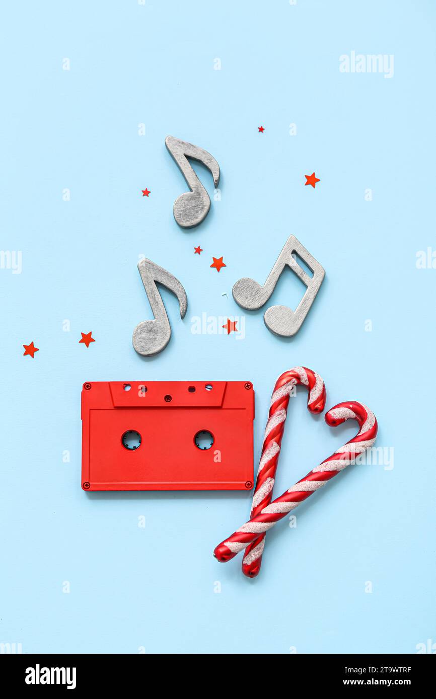 Music notes with audio cassette and candy canes on blue background ...