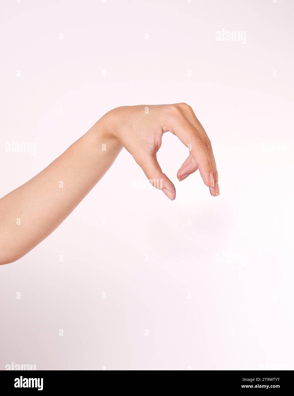 Woman's hand making gesture while grab some items isolated on white ...