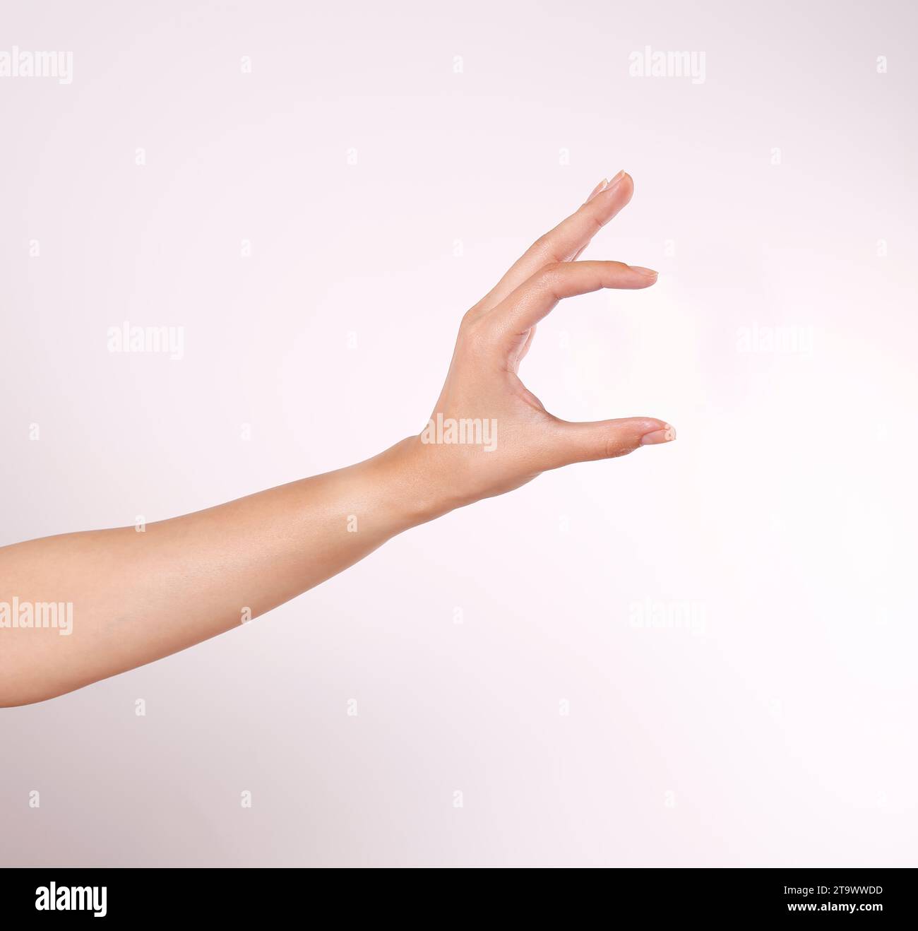 Woman's hand making gesture while grab some items isolated on white ...