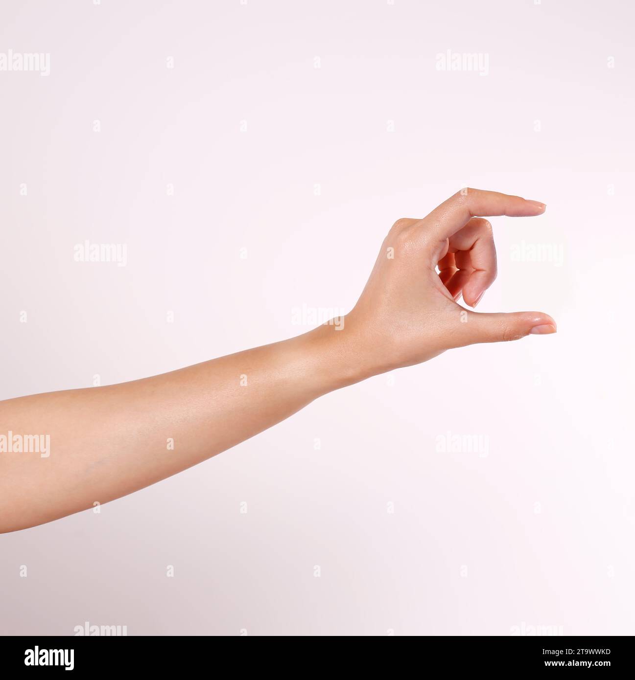 Woman's hand making gesture while grab some items isolated on white ...