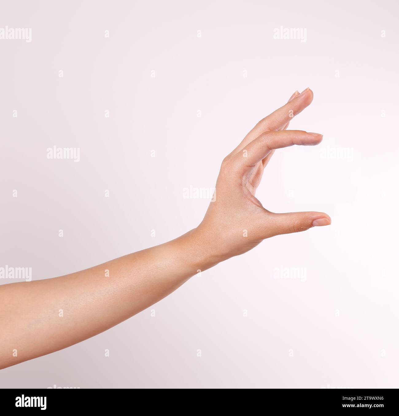 Woman's hand making gesture while grab some items isolated on white ...