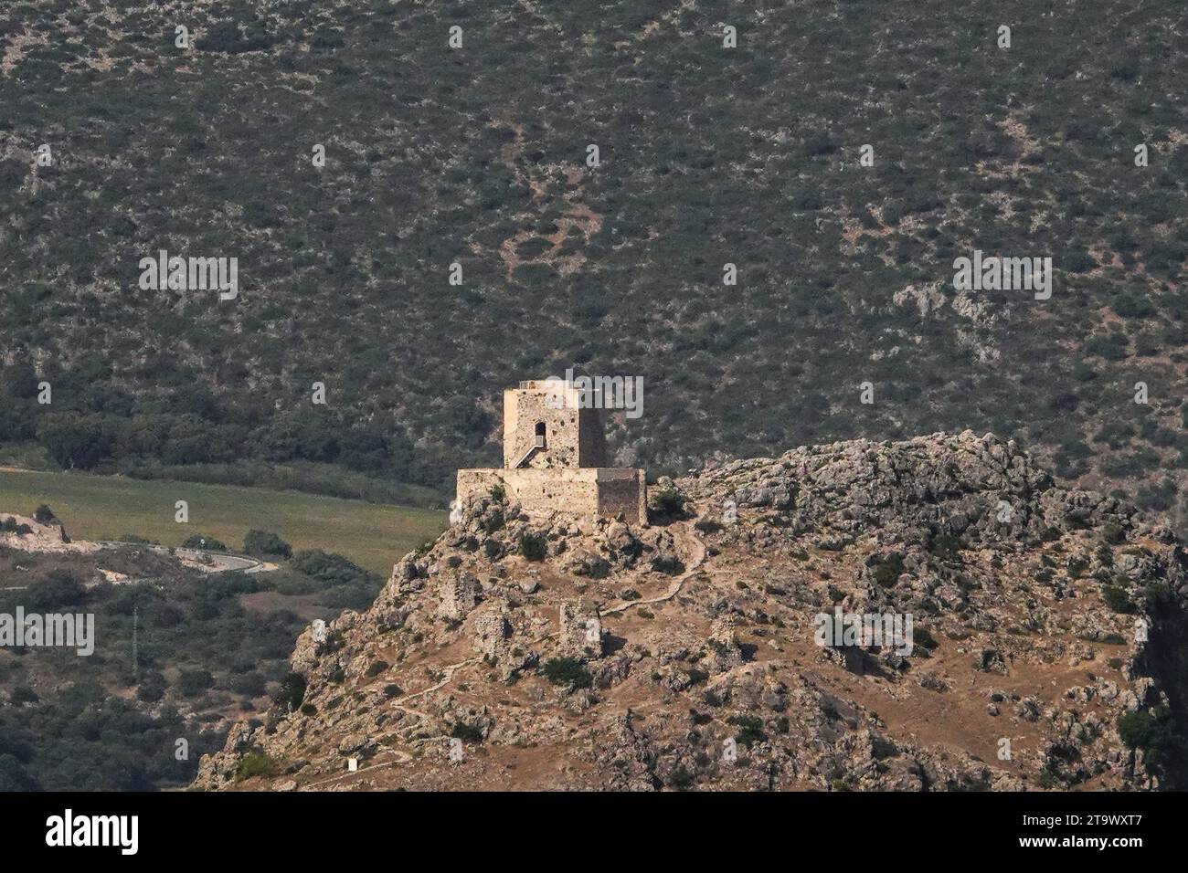 An ancient Moorish watch tower sits on a far hilltop surrounded by ...