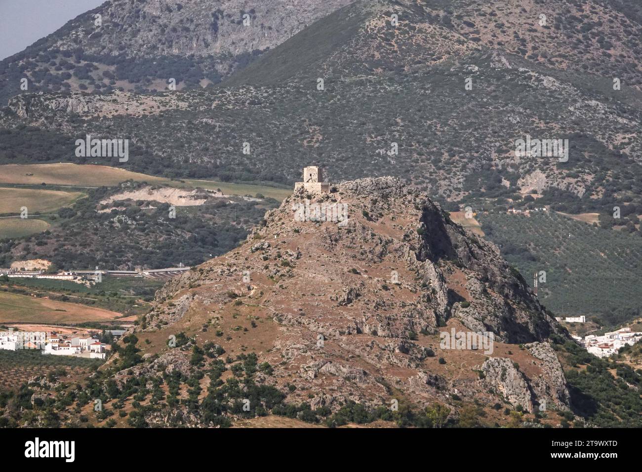 An ancient Moorish watch tower sits on a far hilltop surrounded by ...