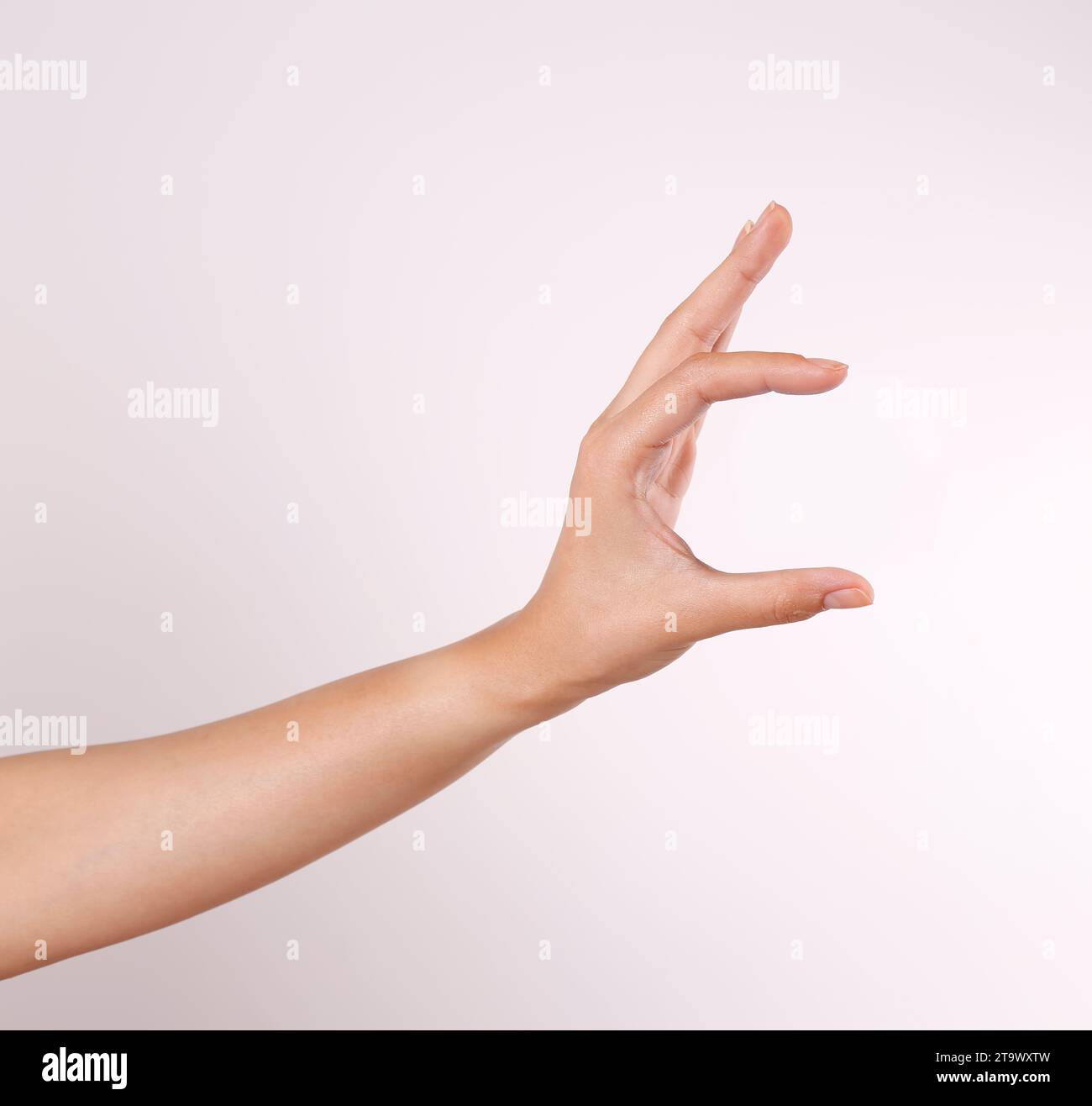 Woman's hand making gesture while grab some items isolated on white ...