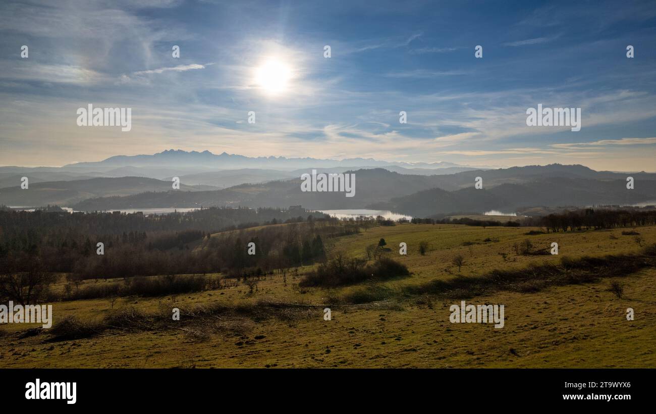 A breathtaking landscape with the sun casting its rays over the rolling ...
