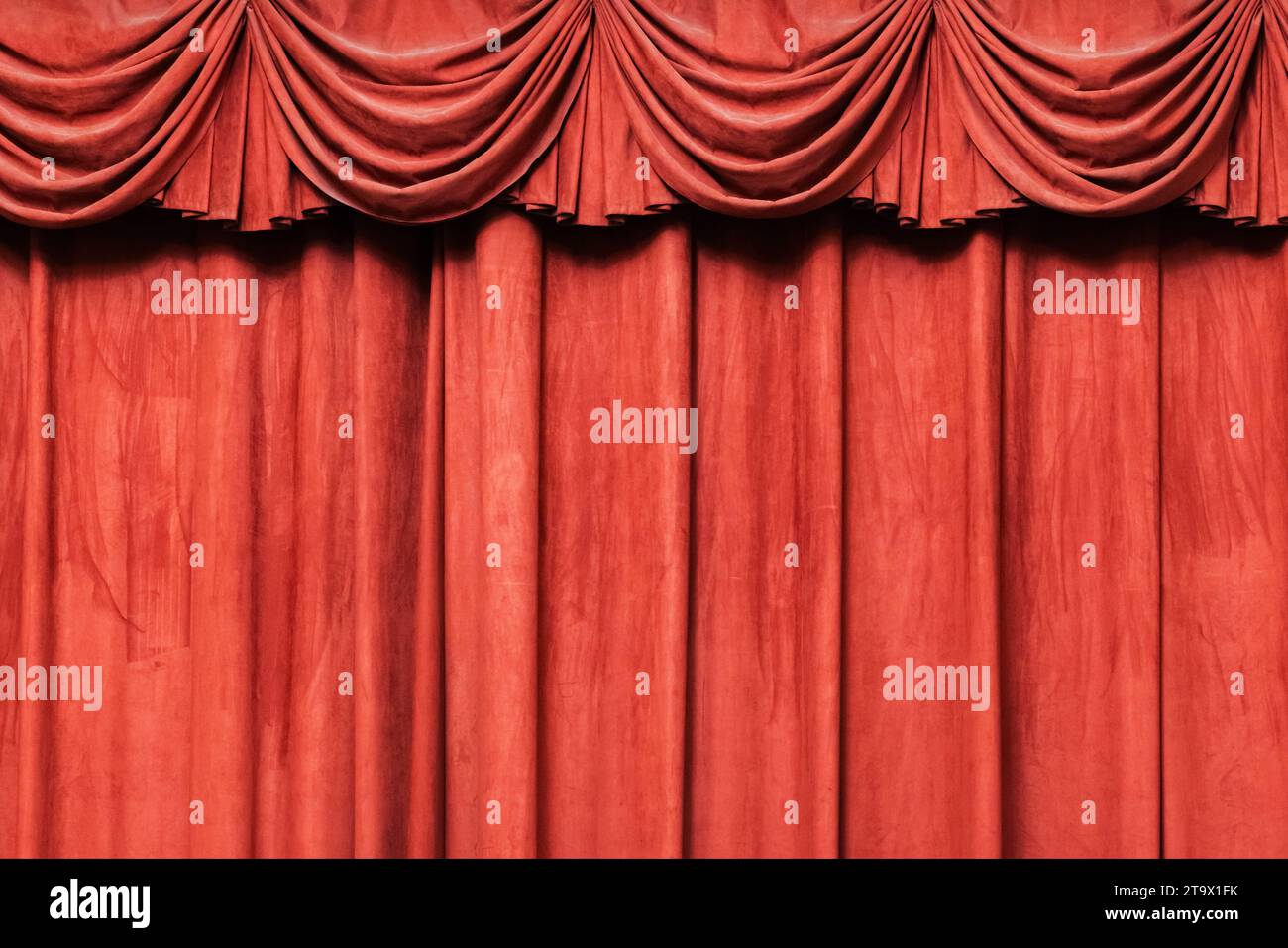 Closed red velvet curtain with wavy drapes, front view, background ...