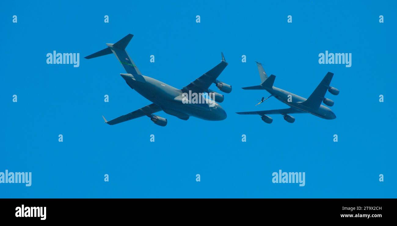 Three large military aircraft soar through the sky in formation, their ...