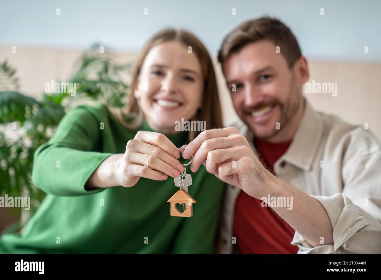 Joyful smiling couple showing keys of own new apartment, house, proud ...