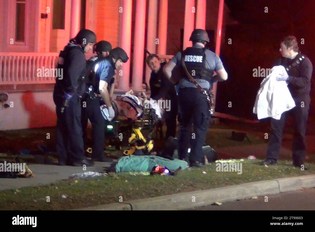 In a still frame from video first responders use a gurney to remove an ...