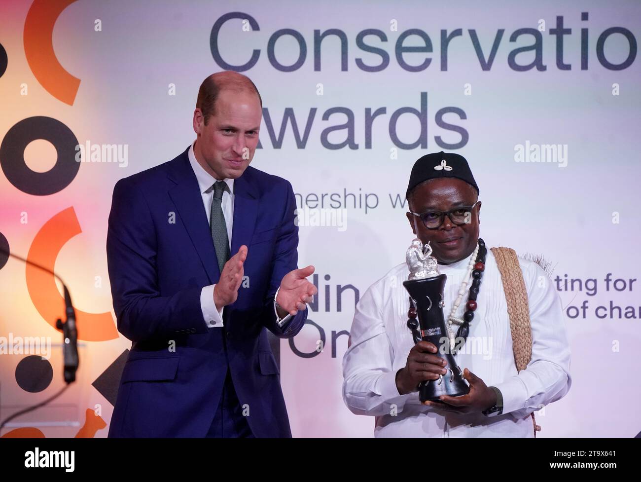 The Prince of Wales (left) presents Dr Ekwoge Abwe from Cameron, with ...