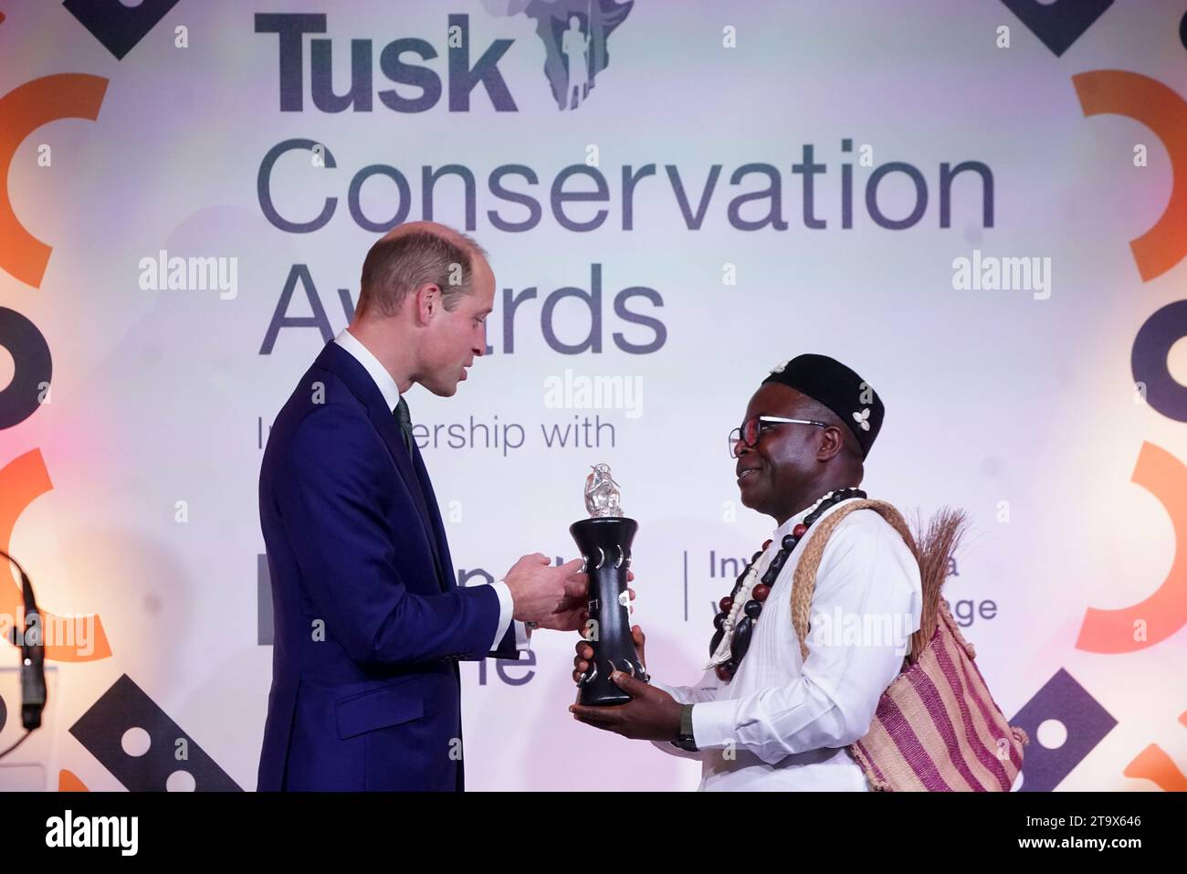 The Prince of Wales (left) presents Dr Ekwoge Abwe from Cameron, with ...