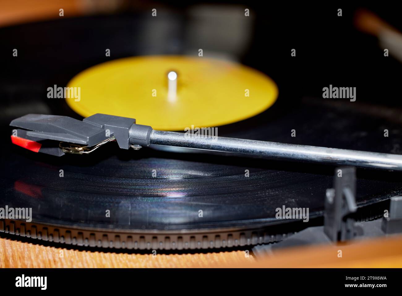 Close up of the Arm of a Turntable getting ready to play a Vinyl Record ...