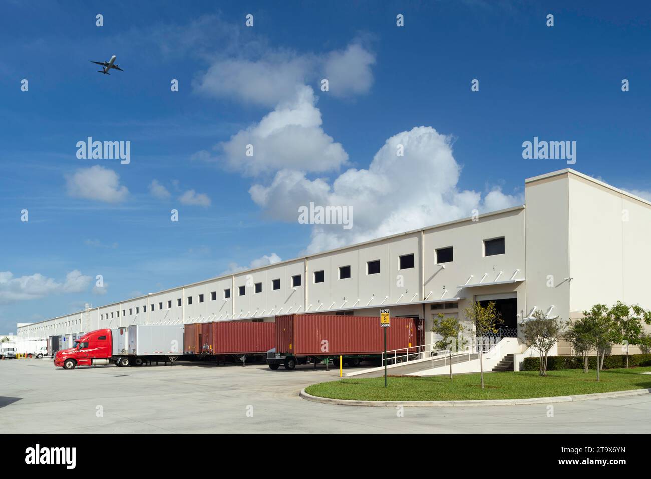 Distribution warehouse with delivery trucks parked on loading docks ...