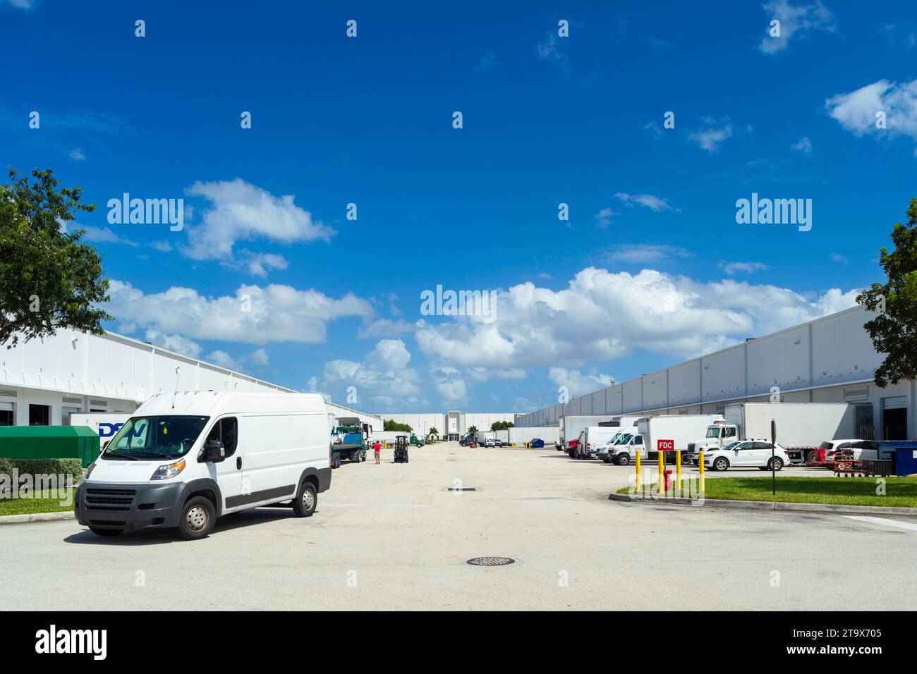 Distribution warehouse with delivery trucks parked on loading docks ...