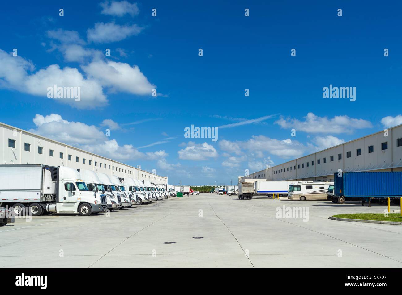 Distribution warehouse with delivery trucks parked on loading docks ...