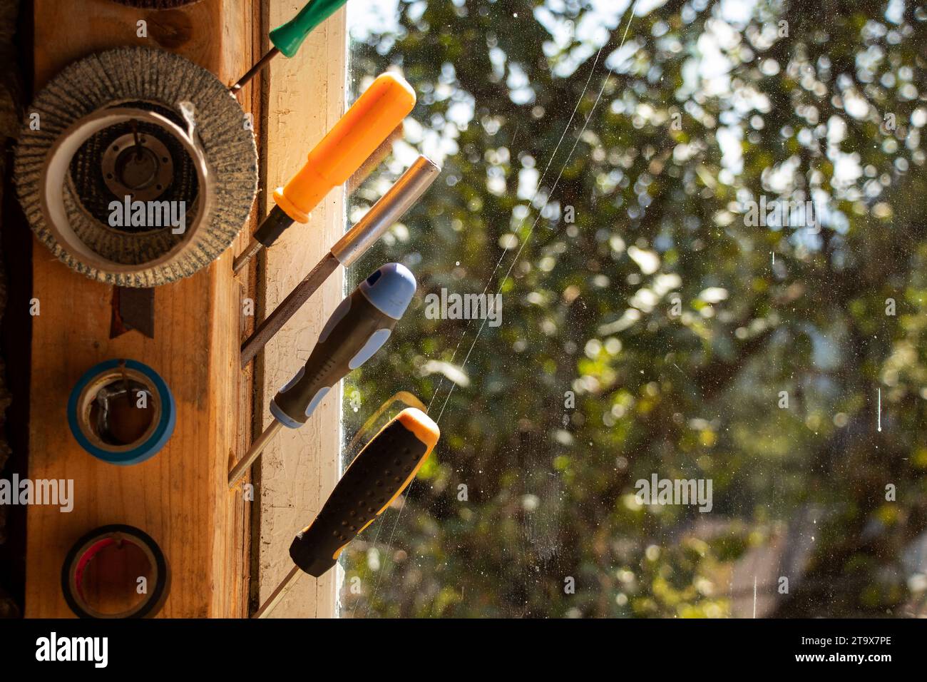 Different types of working screwdrivers and duct tape weigh on the ...