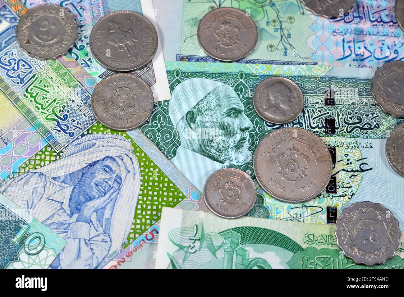 Background of old Libyan money banknote bills and coins of different ...