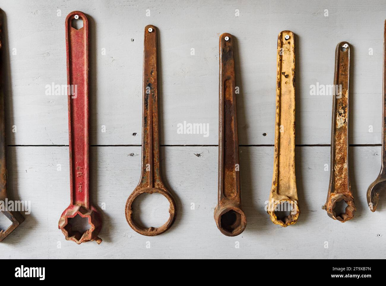 Line of Vintage Tools Hung on Wall - flaking, rusty and old Stock Photo ...