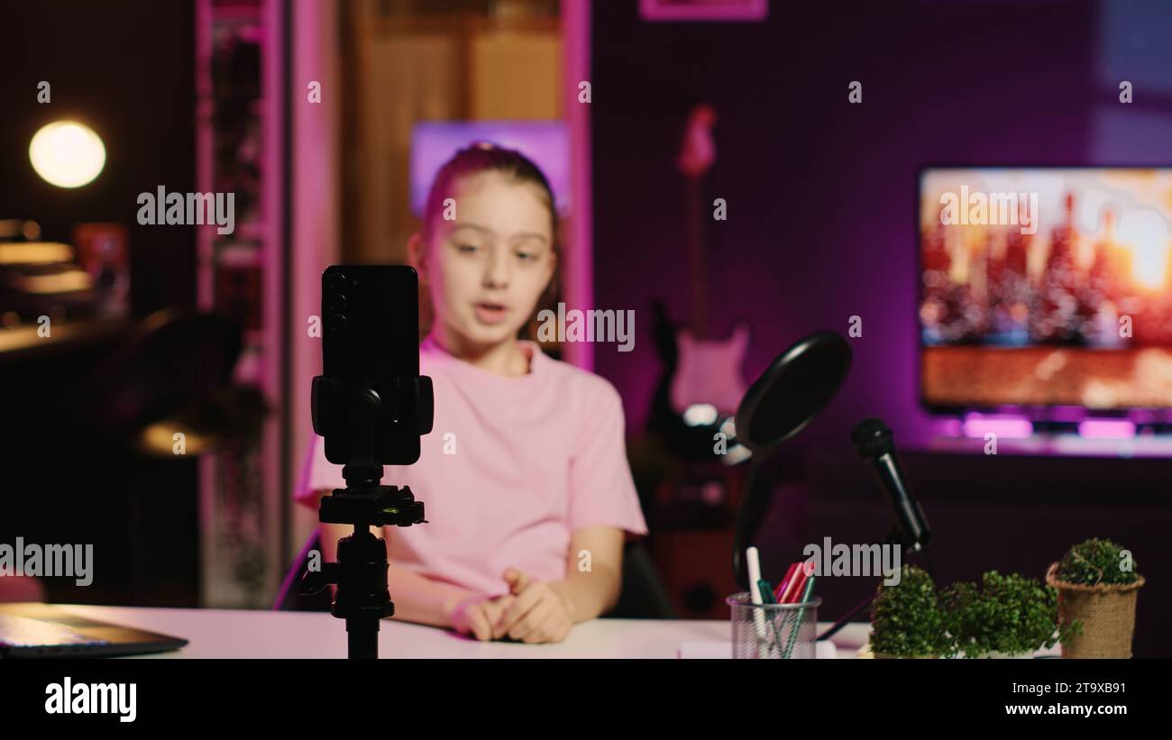 Focus shot on phone attached to tripod used for recording family vlog ...