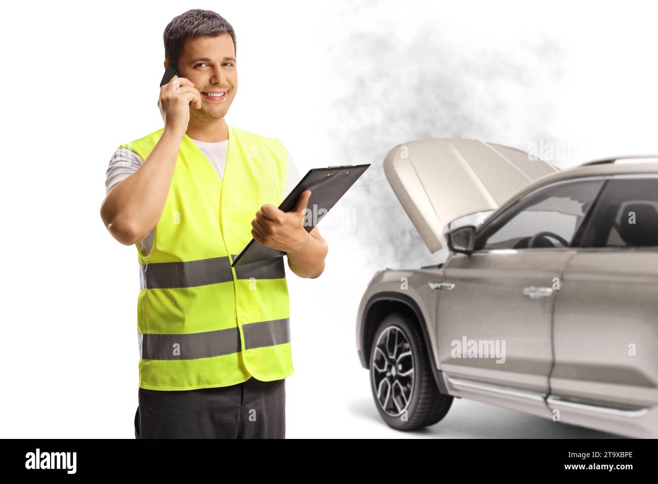 Road help worker with a smartphone standing next to a SUV with open ...