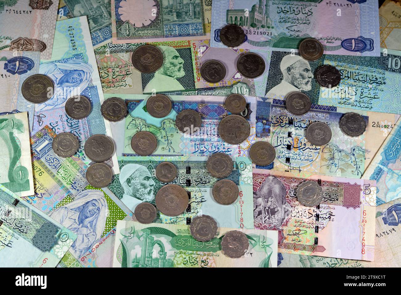 Background of old Libyan money banknote bills and coins of different ...