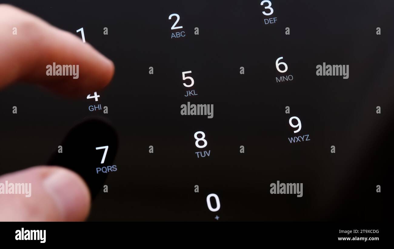 Man's hand finger entering the 4 digit PIN number on a touch screen display unlocking a generic ...