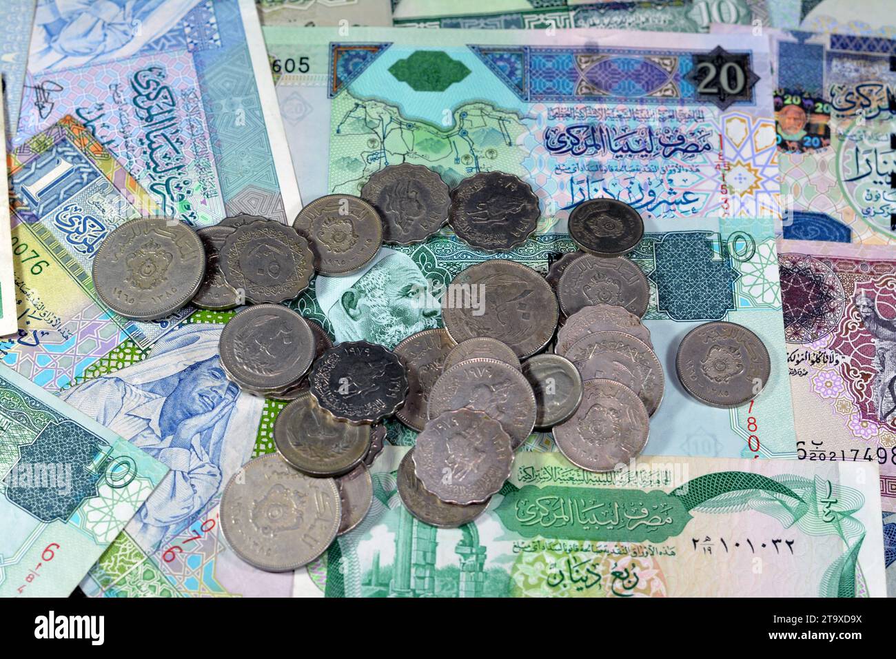 Background of old Libyan money banknote bills and coins of different ...