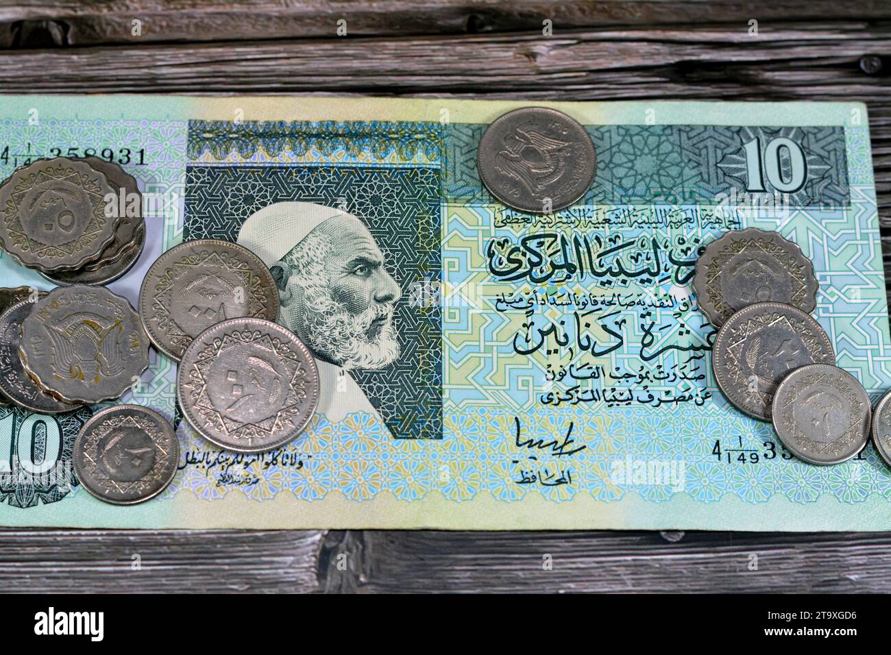 Background of old Libyan money banknote bills and coins of different ...