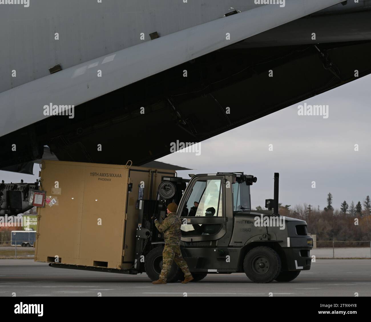 U.S. Air Force Airmen of the 119th Wing maneuvered a forklift to load a ...