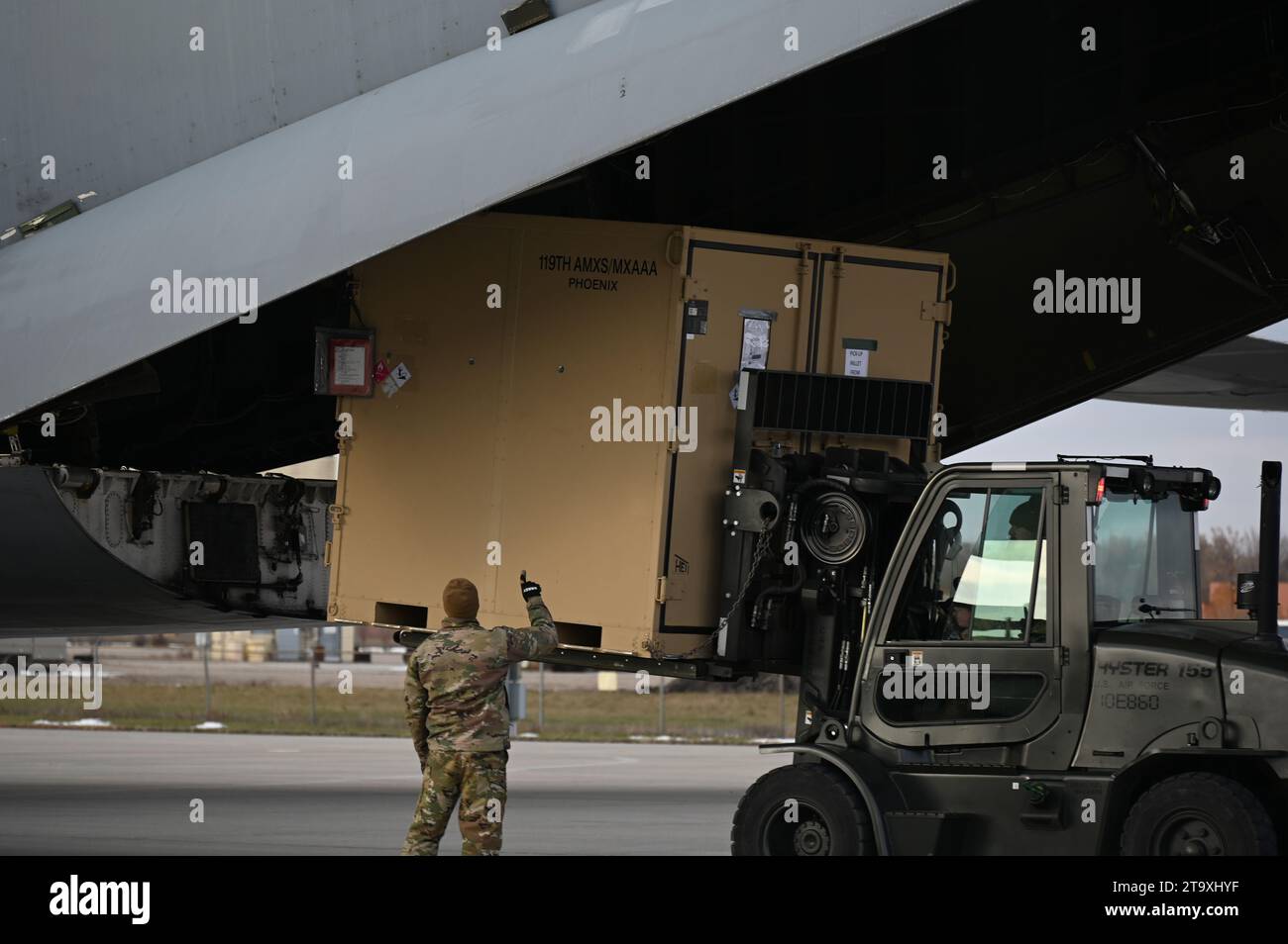 U.S. Air Force Airmen of the 119th Wing maneuvered a forklift to load a ...