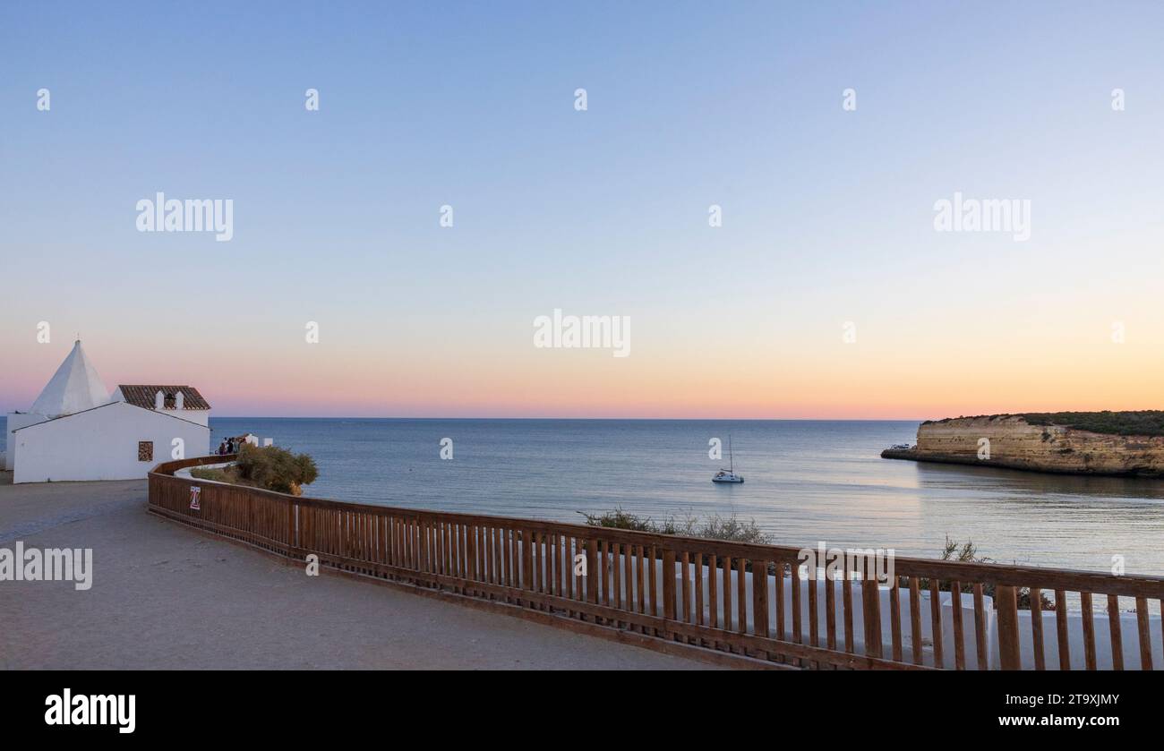 Beautiful sunset on the New Beach (Praia Nova), with the Chapel of Our ...