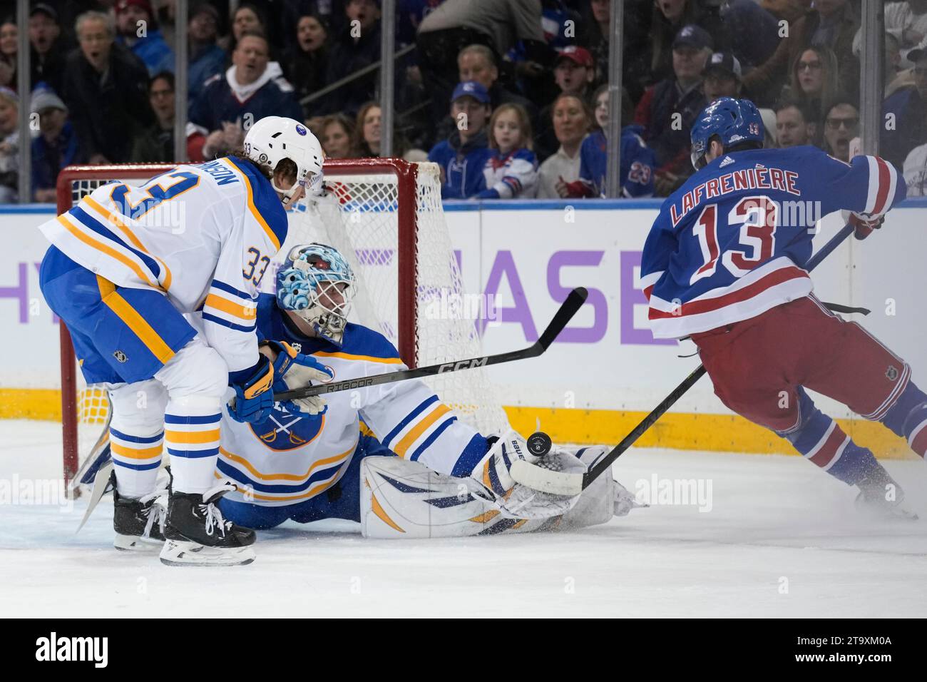 Buffalo Sabres goaltender Ukko-Pekka Luukkonen, center, makes a save ...