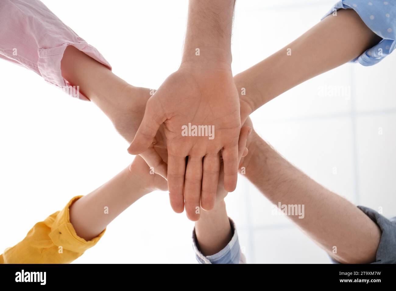People holding hands together indoors, bottom view Stock Photo - Alamy