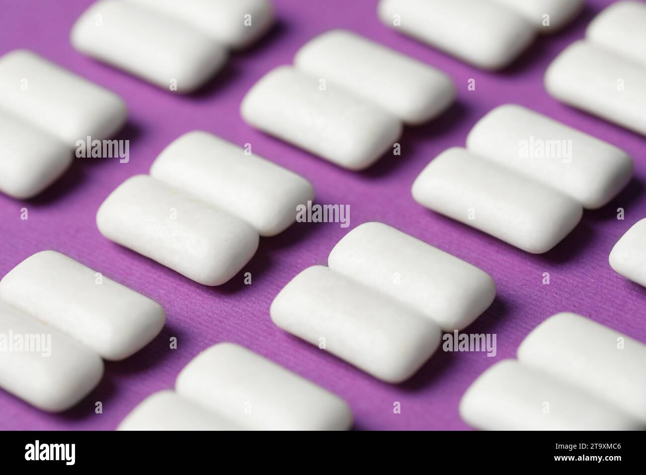Tasty white bubble gums on purple background, closeup Stock Photo - Alamy