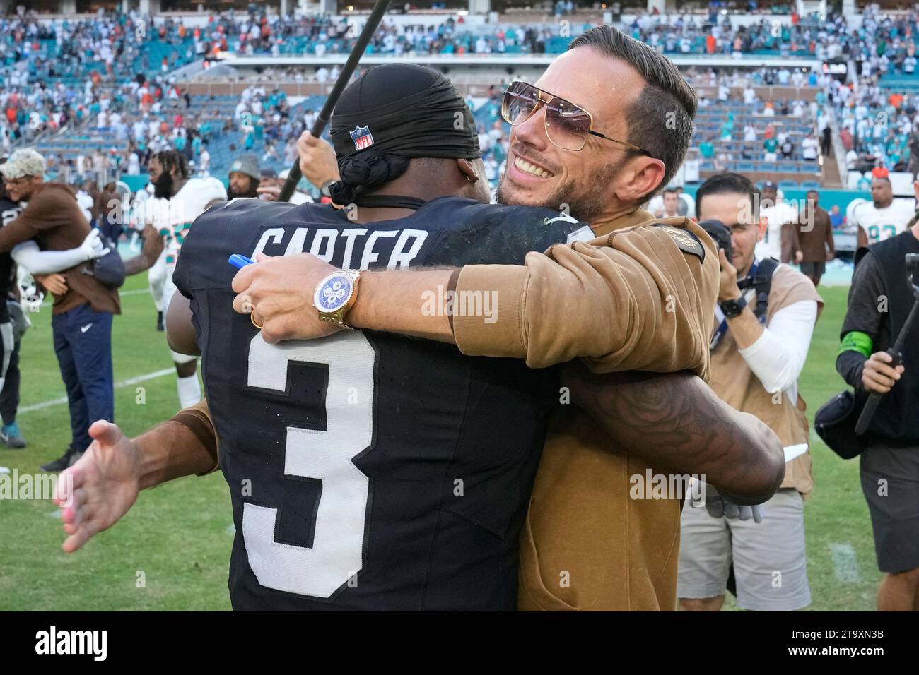 Miami Dolphins head coach Mike McDaniel, right, hugs Las Vegas Raiders ...