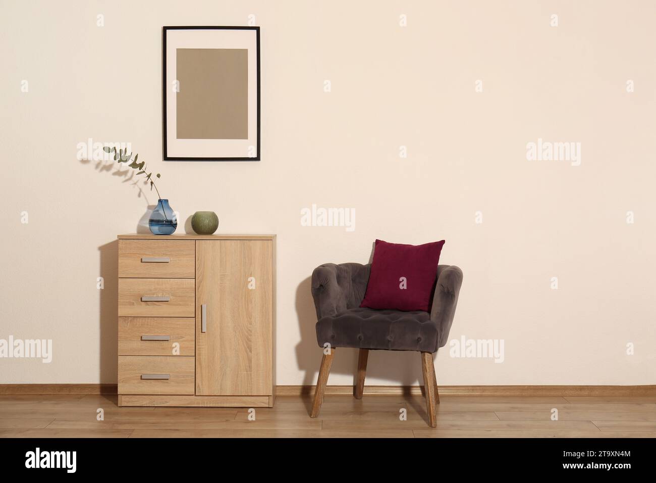 Room interior with armchair and wooden cabinet Stock Photo - Alamy