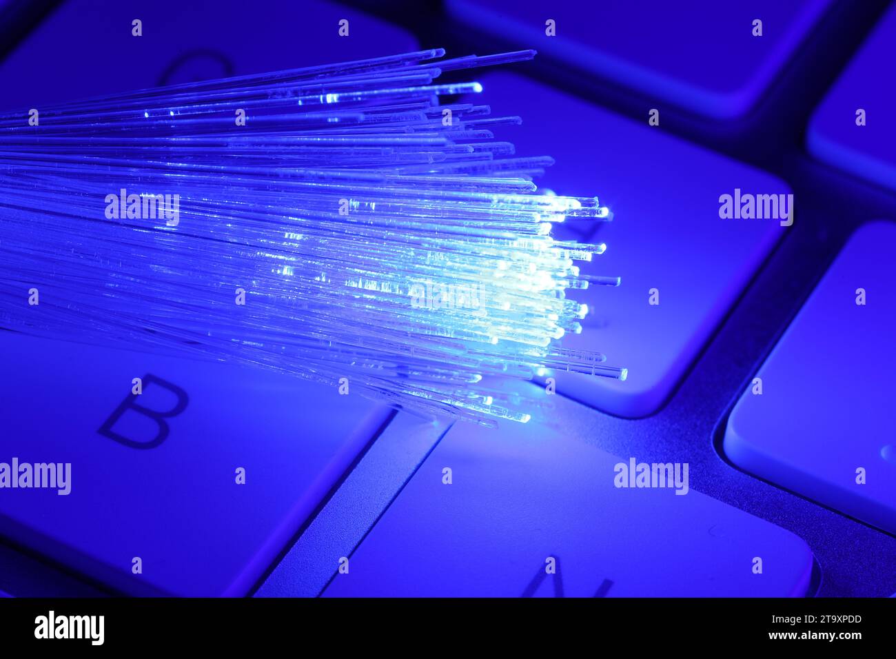 Optical fiber strands transmitting blue light on computer keyboard ...