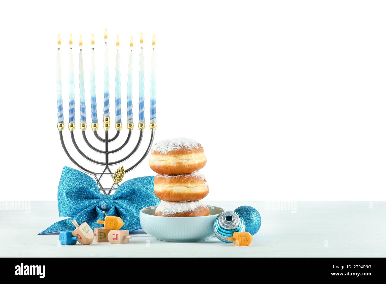 Hanukkah celebration. Composition with menorah, dreidels and donuts on ...