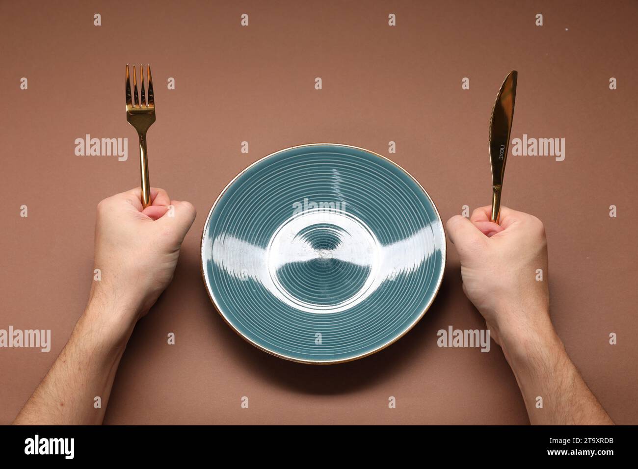 Man holding knife and fork hi-res stock photography and images - Alamy