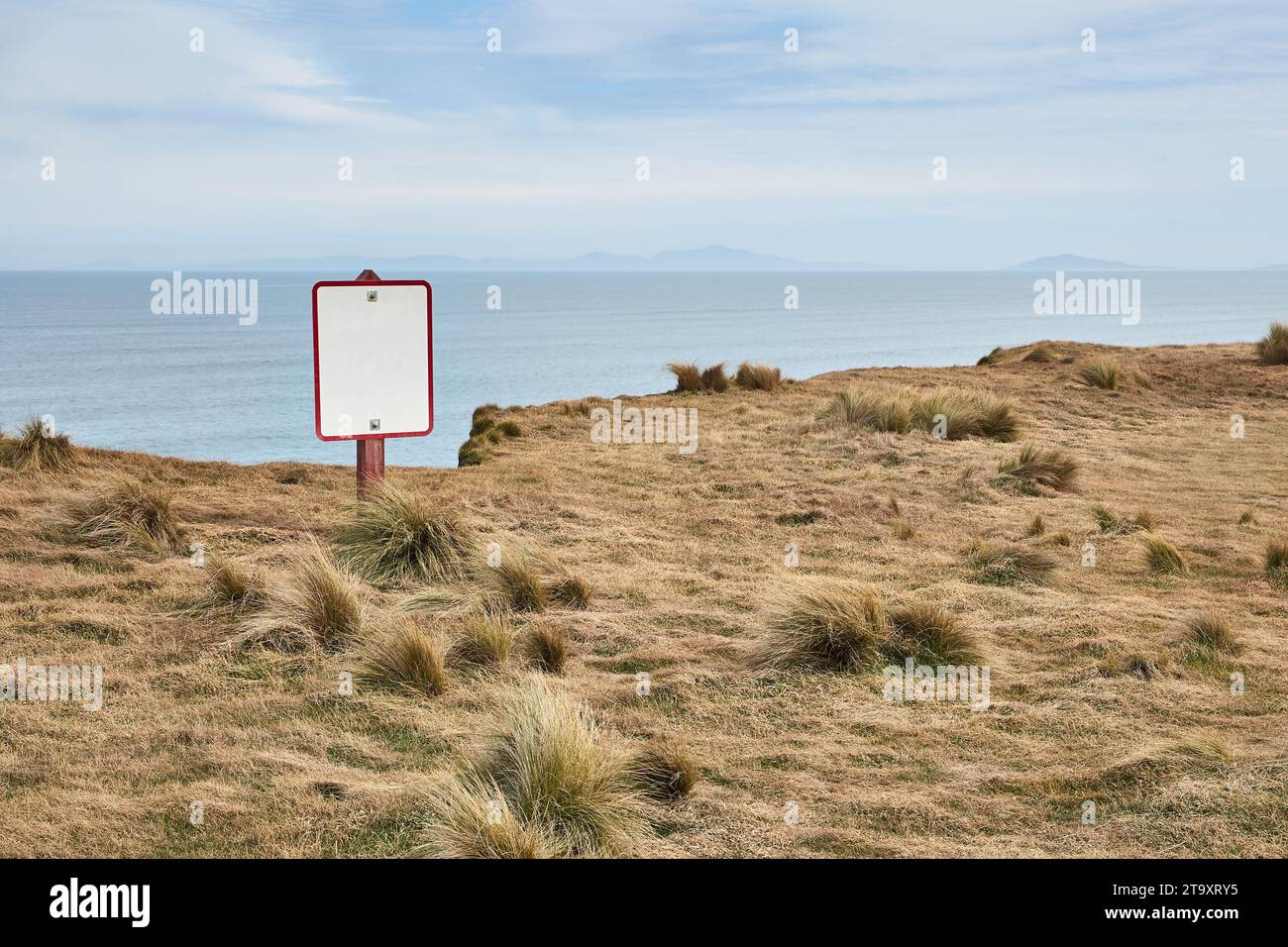Beware of cliff warning sign, coastal landscape Stock Photo - Alamy