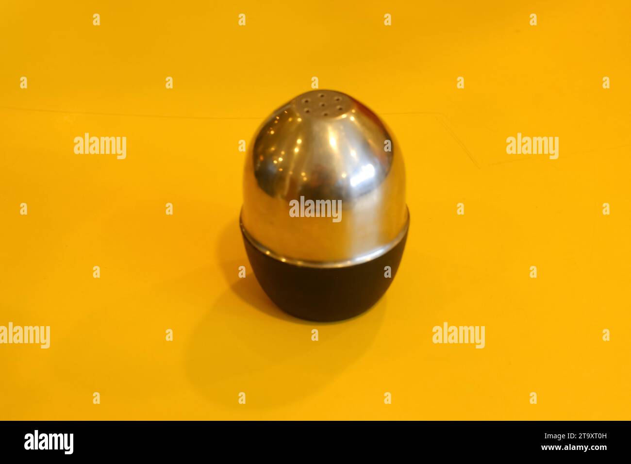 Aluminum container for storing salt on a yellow background Stock Photo ...