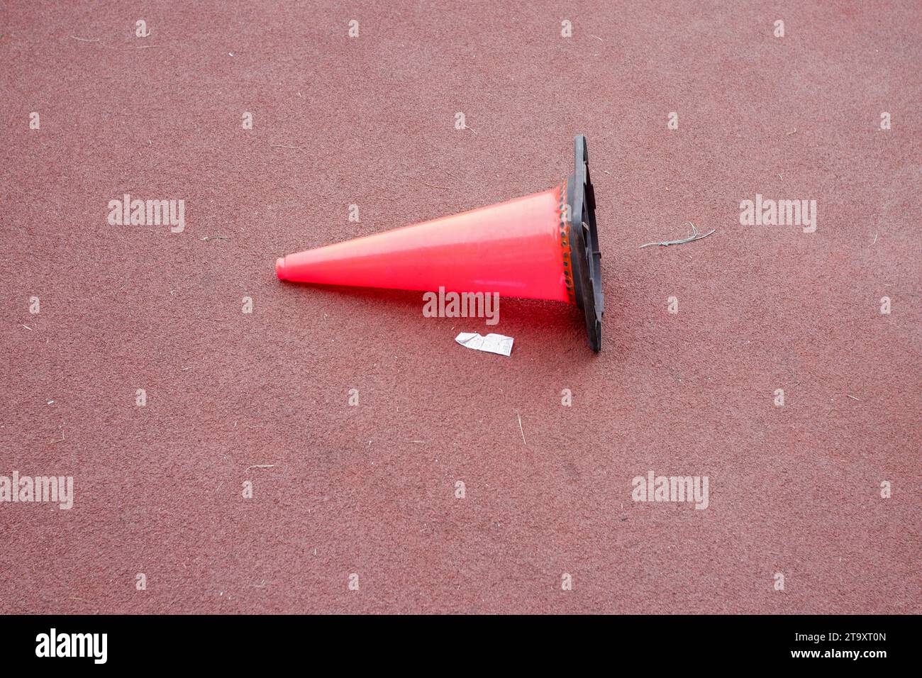 orange safety cones lying on the red running track at the stadium Stock ...