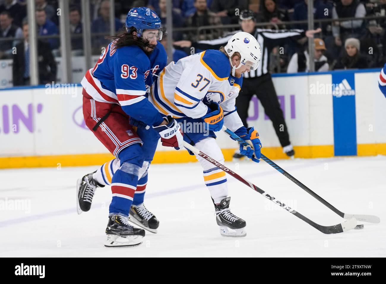 New York Rangers' Mika Zibanejad, left, tries to get the puck from ...