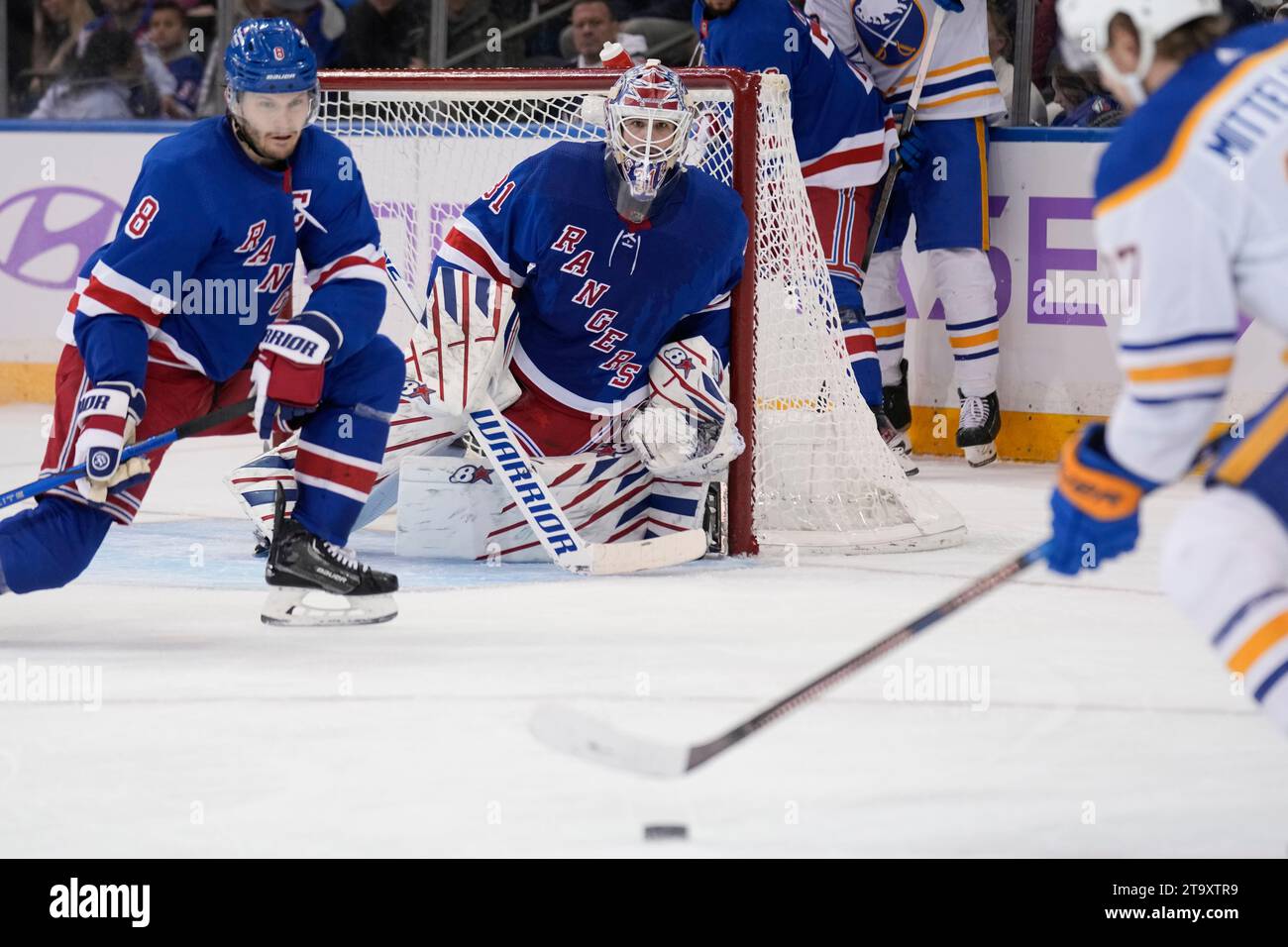 New York Rangers goaltender Igor Shesterkin, center, watches the puck ...