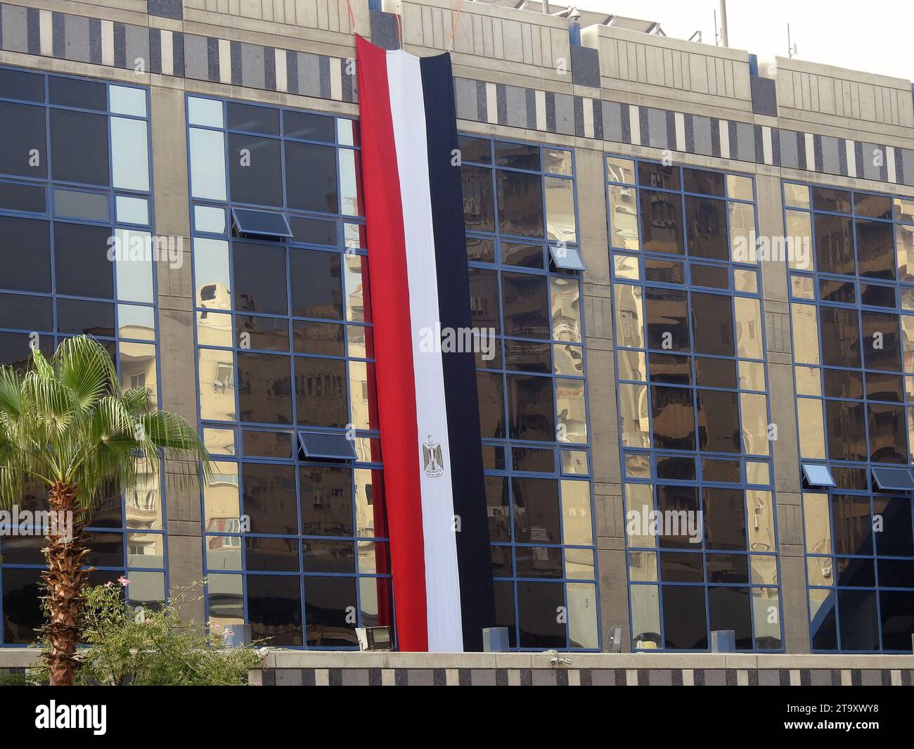 A blue building with the Egyptian flag across the building height ...